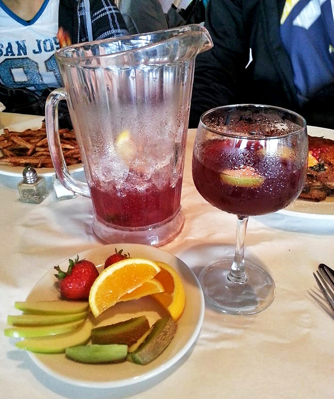 Their sangria arrives with a fruit plate that's not just garnish—it's a supporting actor deserving its own award nomination.