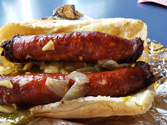 Glistening sausages with caramelized onions on a pillowy roll—the kind of sandwich that makes you temporarily forget your name.