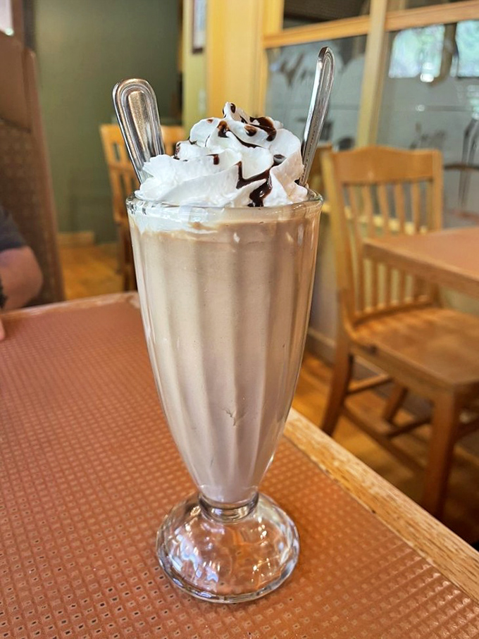 Remember when milkshakes were actual achievements? This towering creation brings back childhood joy with grown-up execution—nostalgia in a glass.