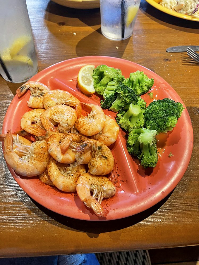 Simple, perfect shrimp with a side of broccoli for those pretending to be virtuous. The lemon wedge isn't a suggestion – it's the finishing touch.