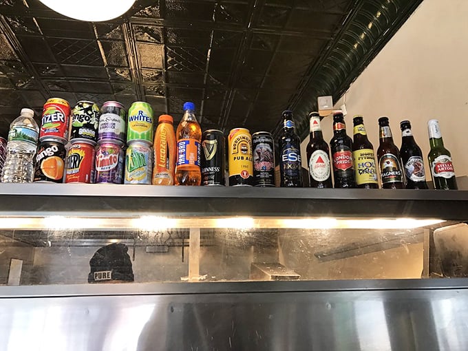 A proper chippy experience demands proper beverages. The shelf displays imported British sodas and beers that complement the authentic fish and chips experience.