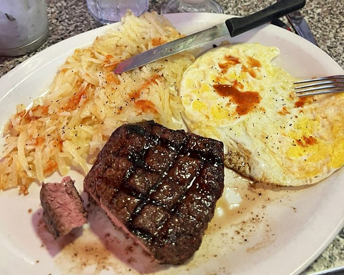 The steak and eggs plate doesn't just say "good morning"—it shouts it from the rooftops with a perfectly grilled cut and eggs sunny enough to brighten your day.