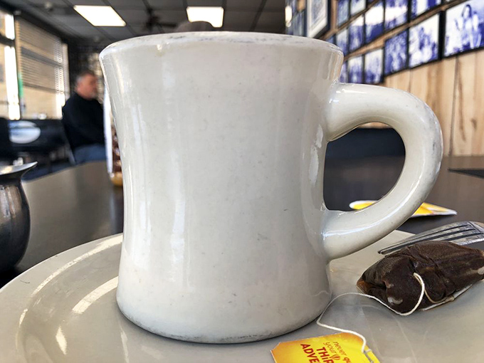 The humble diner mug—holding the elixir of life that transforms grumpy morning zombies into functioning humans since forever.