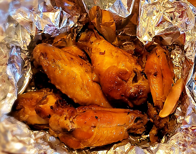 Wings that glow with the amber hue of proper smoking—these aren't bar food afterthoughts but carefully crafted protein delivery vehicles for sauce.