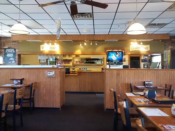 The warm, wood-paneled interior feels like a pizza party waiting to happen—just add friends and appetite.