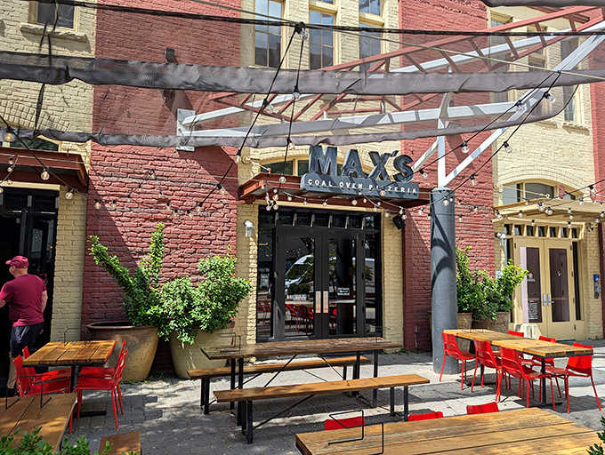 Those red chairs aren't just for sitting—they're front-row seats to the smoky, charred perfection that only comes from coal-fired ovens.