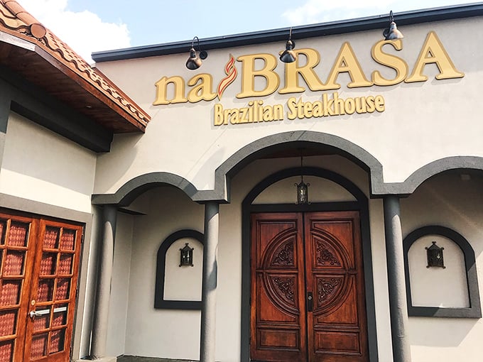 The warm stucco exterior and dramatic entrance at NaBrasa set the stage for the theatrical dining experience waiting inside.