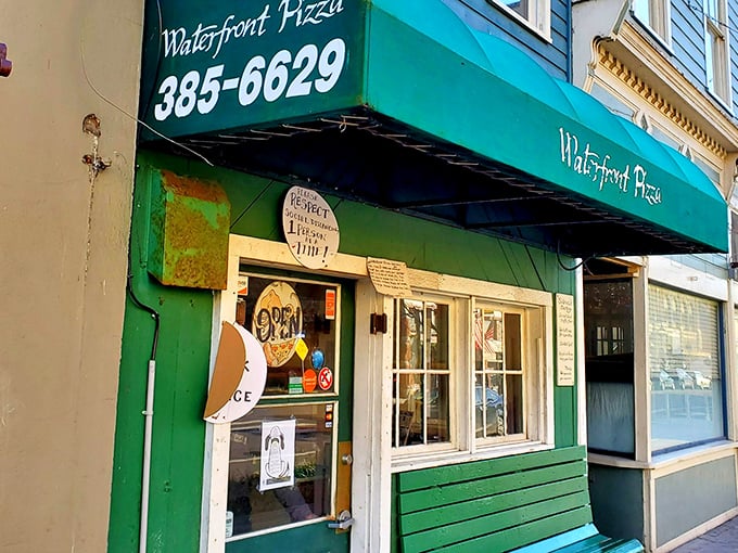 The weathered charm of Waterfront Pizza's storefront tells you this place has stories to tell—and most of them involve really good pizza.