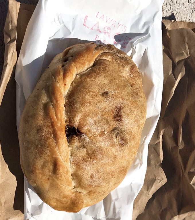 Behold the pasty in its natural habitat—wrapped in paper, ready for transport, and destined for greatness in your immediate future.