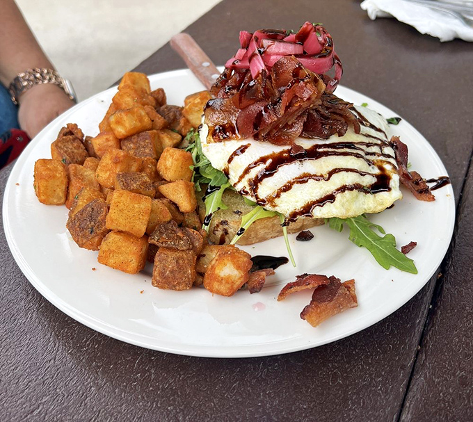 Brunch architecture at its finest – perfectly toasted bread supporting a mountain of toppings with the structural integrity of the Golden Gate Bridge.