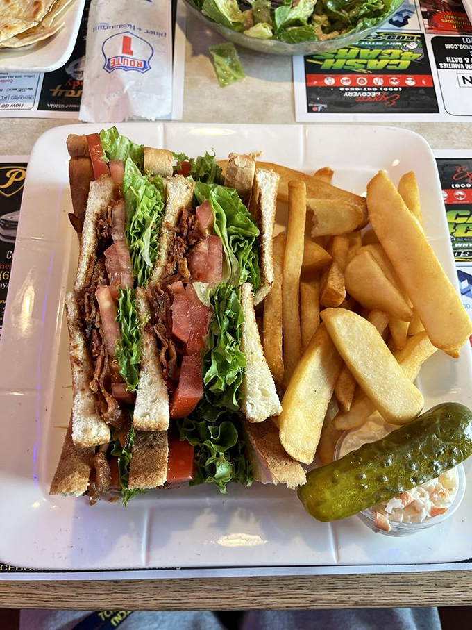 Architecture in sandwich form. The BLT stands tall with crisp lettuce, ripe tomato, and bacon in perfect harmony – the skyscraper of lunch options.