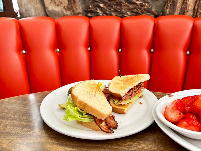 A proper BLT served against that iconic red vinyl—proof that three simple ingredients, when respected, can outshine the fanciest tasting menu.