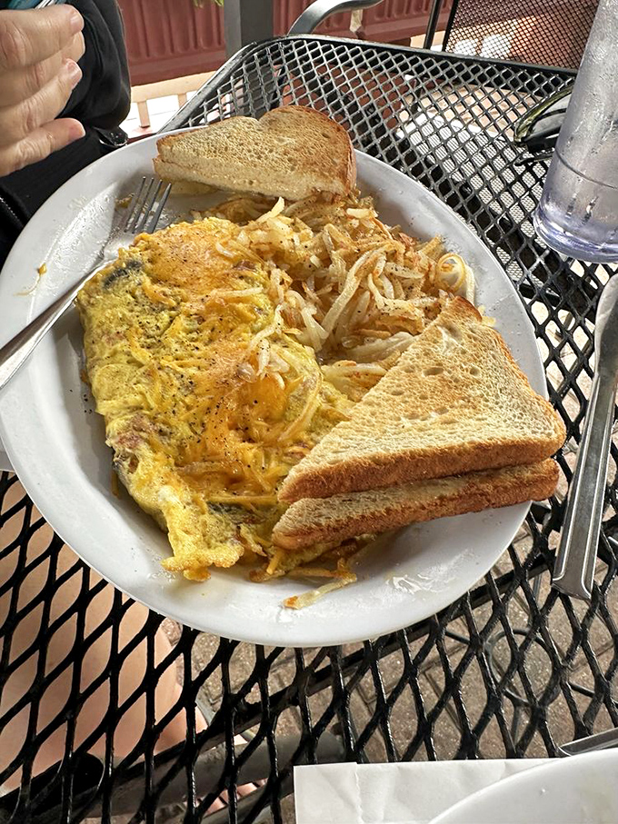 This isn't just an omelet—it's a morning masterpiece where eggs, cheese, and perfectly crisped hash browns perform a harmonious breakfast ballet.