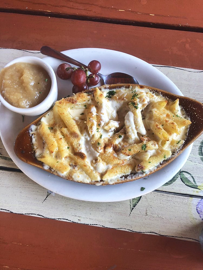 Mac and cheese that's gone to finishing school—baked to bubbling perfection with a side of applesauce that somehow makes perfect, childlike sense.