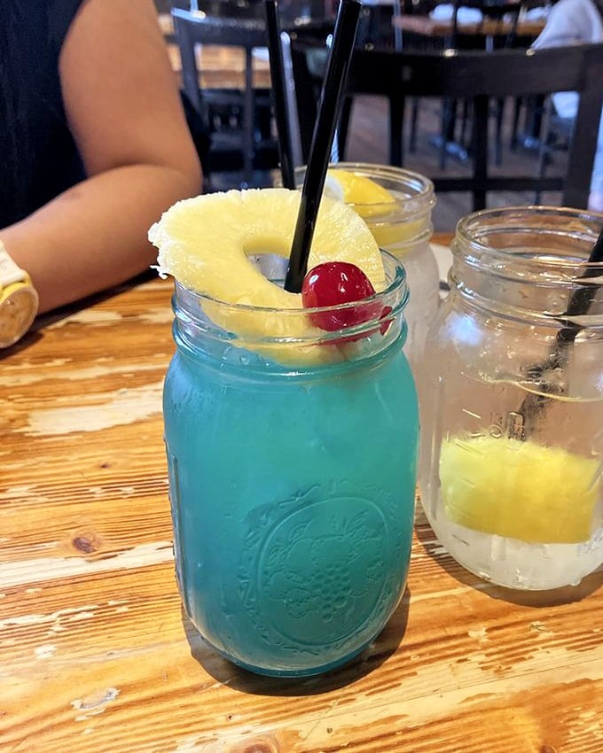 The Blue Bayou cocktail—electric blue and vacation-ready. This mason jar of tropical escape comes with a pineapple life preserver and cherry on top.