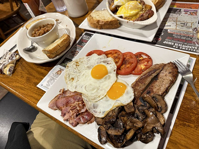 A breakfast spread that would make Ron Swanson weep with joy – eggs, bacon, toast, and home fries in perfect harmony.