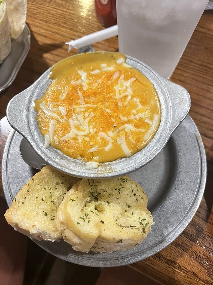 A bowl of sunshine: creamy broccoli and cheese soup with garlic bread for dipping—comfort food that hugs you from the inside.