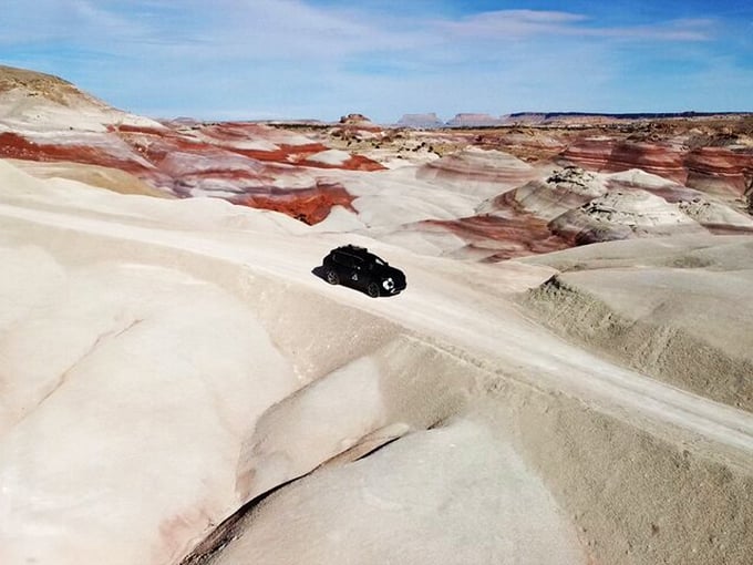 "Just a little off-road," they said. This intrepid Jeep navigates the otherworldly terrain of Cathedral Valley like a black ant on a wedding cake.