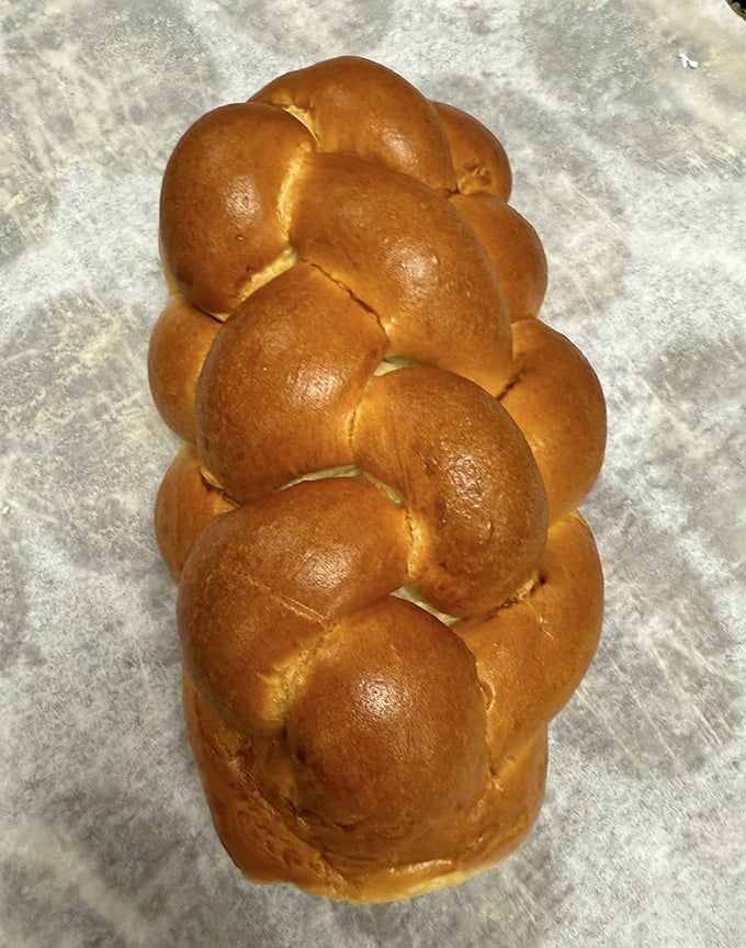 This isn't just bread—it's a golden-brown masterpiece of braided challah. Tear off a piece and experience what clouds would taste like if they were bread.