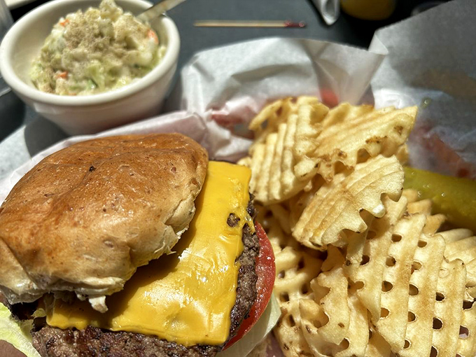 A classic diner cheeseburger with waffle fries – proof that simplicity, when executed perfectly, needs no fancy embellishments or truffle oil.