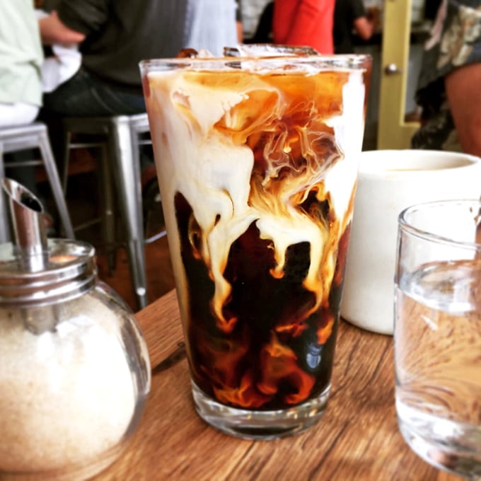 Coffee art that's practically hypnotic—swirls of cream meeting dark espresso in a morning dance that beats any alarm clock.