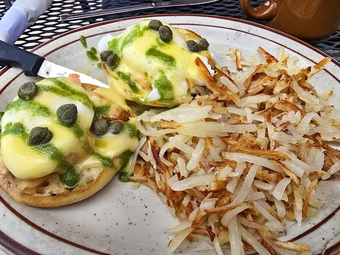 The Colorado Benedict—where hollandaise meets green chili in a breakfast summit that deserves its own peace prize. Those hash browns are crispy perfection.