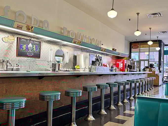 The counter where strangers become neighbors and solo diners never feel alone—a front-row seat to the soda fountain ballet that's been performed since 1946.