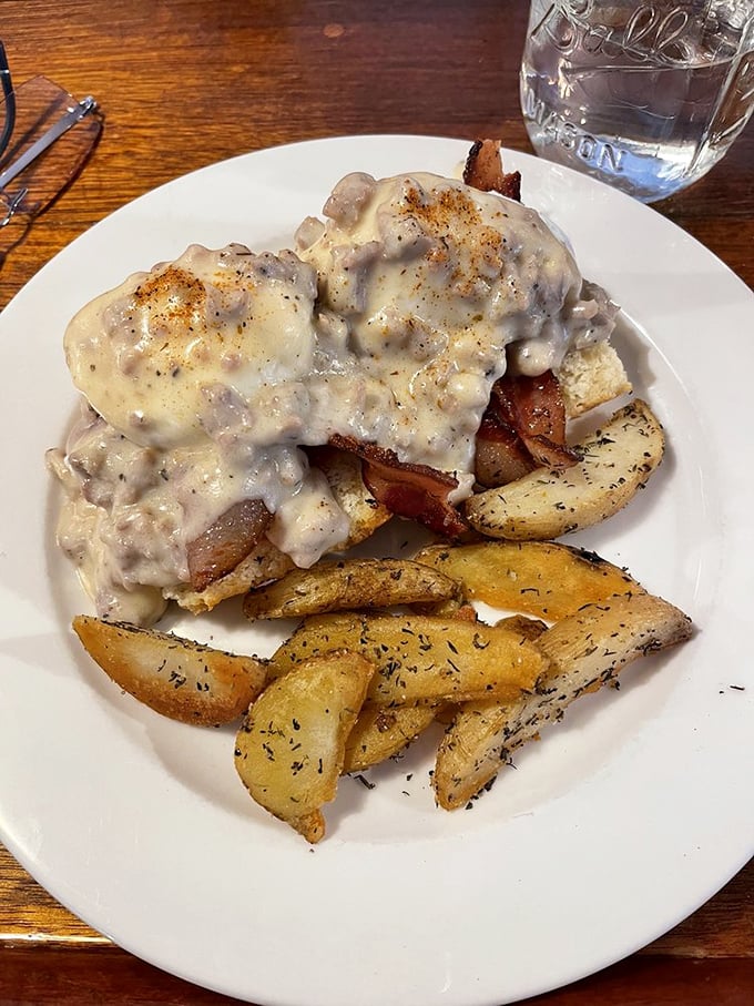 This isn't just breakfast, it's a monument to morning indulgence – eggs and biscuits baptized in gravy that could make a vegetarian reconsider.