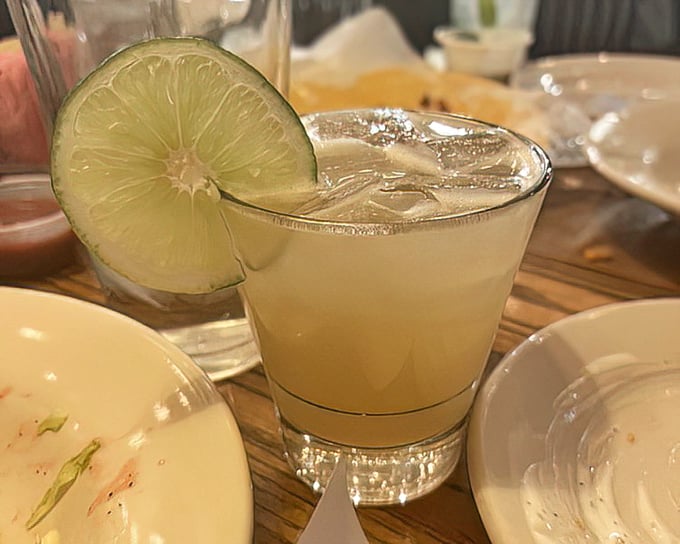 A perfectly chilled margarita with a lime wedge perched on the rim—the ideal companion for navigating a Texas-sized menu.