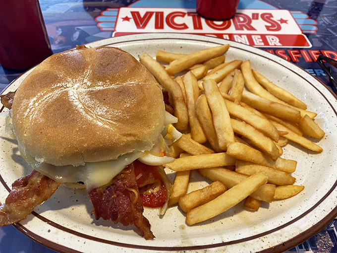 A burger that Dean Martin would approve of—simple, substantial, and without pretension. Those perfectly golden fries aren't just a side—they're a declaration of diner principles.