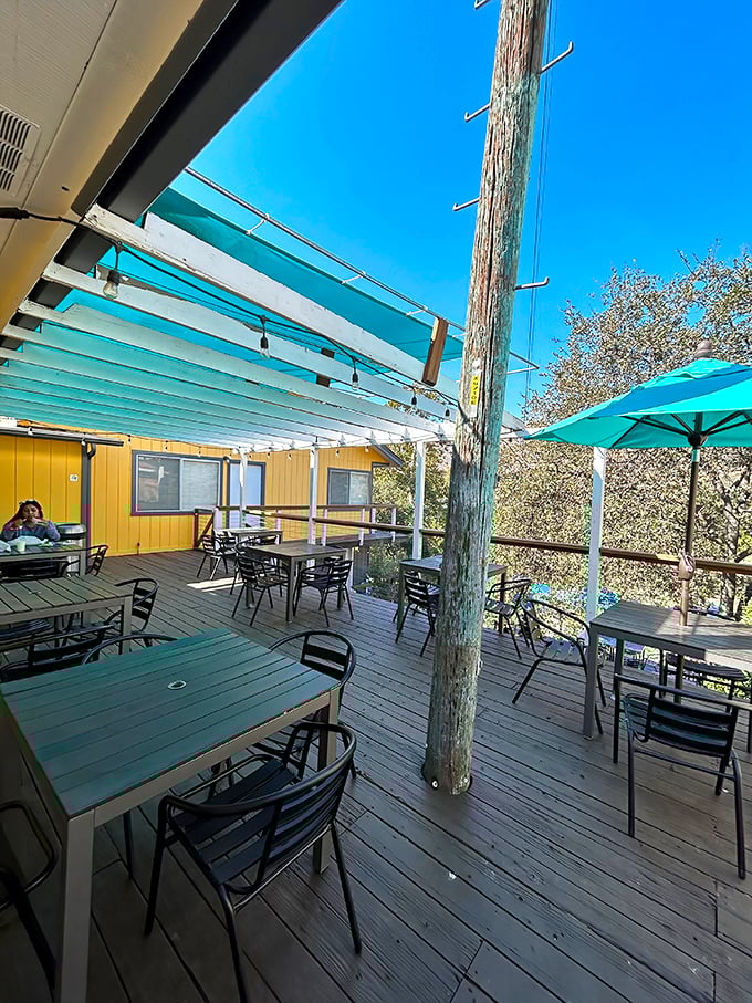 The blue canopy creates an oasis of shade where hungry hikers and locals alike escape the mountain sun while plotting their next sandwich conquest.