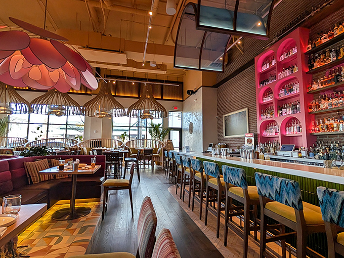 The dining area blends warm woods with vibrant colors and those signature flower lights. It's like being inside a stylish piñata without the fear of being blindfolded.
