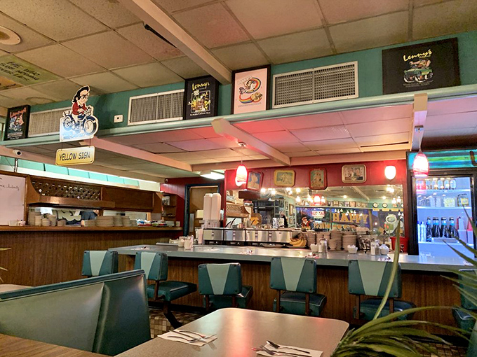 The counter seating area—where breakfast dreams come true and coffee cups never reach empty. Diners' paradise in turquoise and wood.