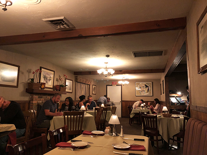 Warm lighting and white tablecloths create that perfect balance between casual comfort and special occasion dining.