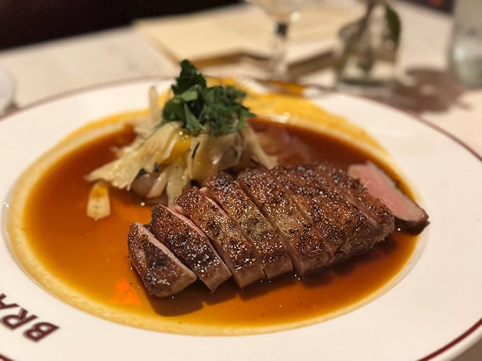 Duck breast, sliced with mathematical precision, lounging in its own magnificent jus—a dish that demands to be savored slowly.