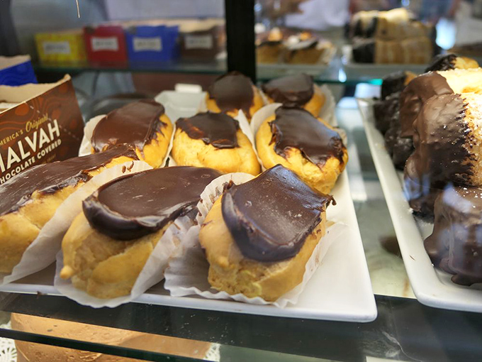 These chocolate-topped eclairs aren't just desserts; they're time machines to childhood joy—creamy, chocolatey perfection that makes diets wave white flags of surrender. Photo credit: <a href="https://www.yelp.com/user_details?userid=cI5puqZckvEnpFGpwDOcKQ" target="_blank" rel="noopener noreferrer">Lewis C.</a>