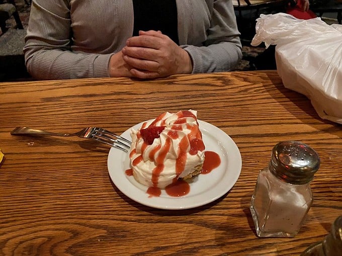 When cheesecake wears a strawberry beret, it's not just dessert—it's a sweet finale that makes you contemplate ordering a second slice "for the road."