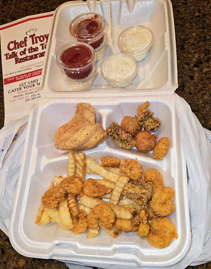 The seafood sampler to-go proves good things come in styrofoam packages—especially when those things include perfectly fried coastal treasures. 