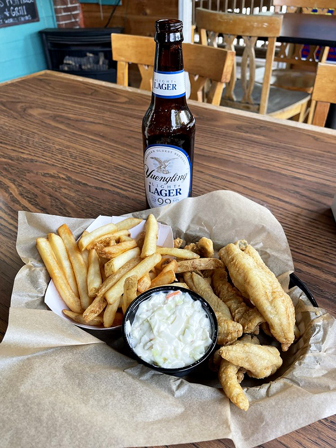 A cold Yuengling beside perfectly golden fish and chips—proof that sometimes the simplest pleasures are the most profound.