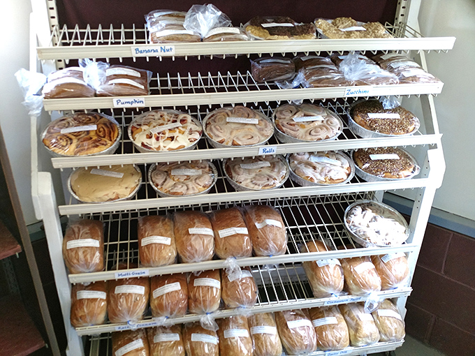 The white wire shelving might be simple, but what it holds is pure culinary poetry—breads and rolls that would make a cardiologist weep.