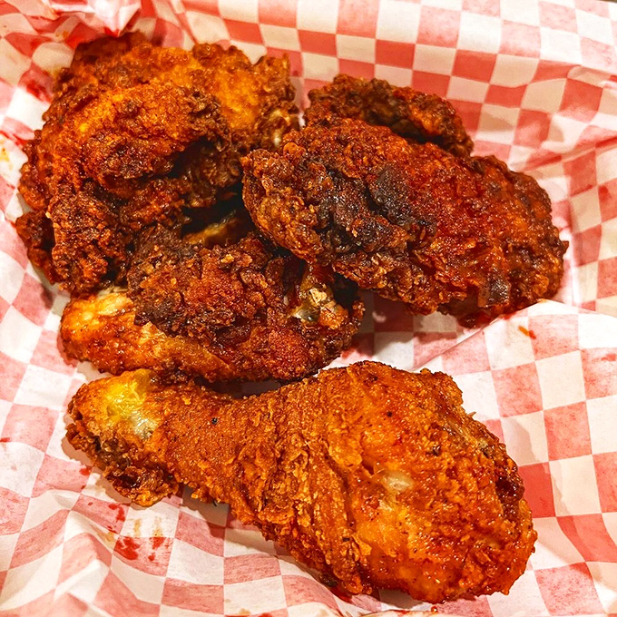 Fried chicken so gloriously golden and crispy, it makes you wonder why anyone bothers with fancy food when perfection comes in a checkered basket.