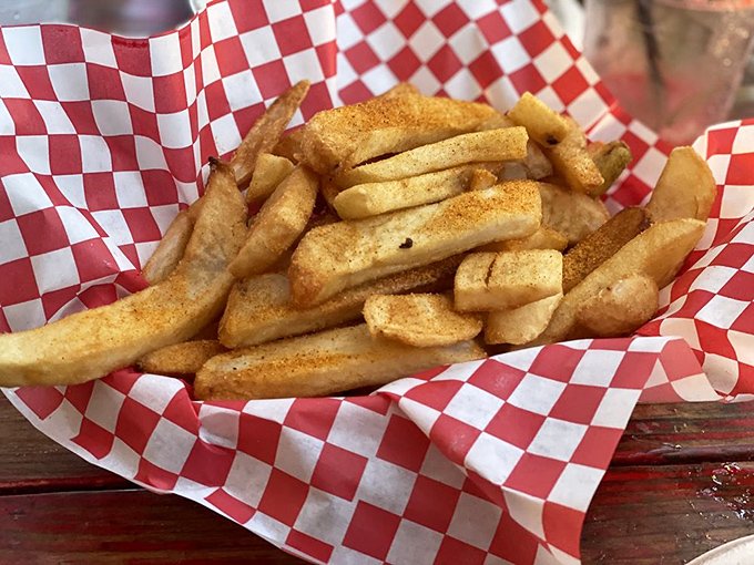 These aren't just fries—they're the supporting actors that deserve their own Oscar, dusted with seasoning and served in classic checkered paper.