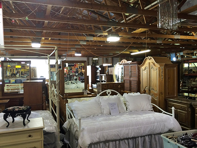 Elegantly staged bedroom furniture creates tiny islands of domestic tranquility—that white daybed practically whispers "curl up with a book and forget your to-do list."