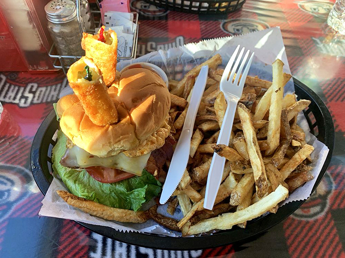 A burger so impressive it deserves its own tiny flag. Those hand-cut fries aren't just a side—they're co-stars in this meal.