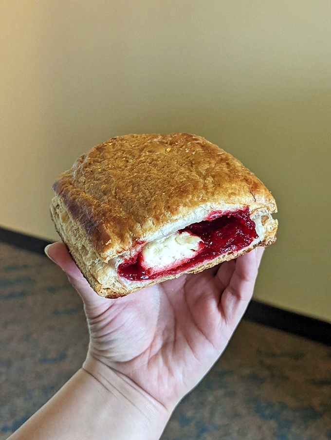 This guava and cheese pastelito reveals its treasure like a culinary sunset – layers of pastry giving way to that perfect sweet-tangy filling that haunts dreams.
