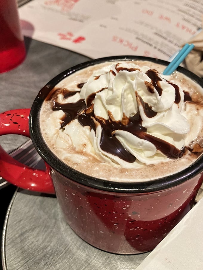 Not just hot chocolate—it's liquid therapy in a rustic mug. Whipped cream and chocolate drizzle turn morning medicine into pure indulgence.