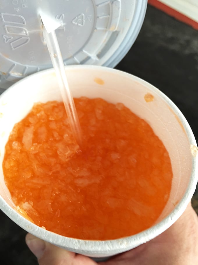 That vibrant orange drink isn't just refreshing—it's liquid sunshine in a cup, the perfect companion for a hot Missouri day.