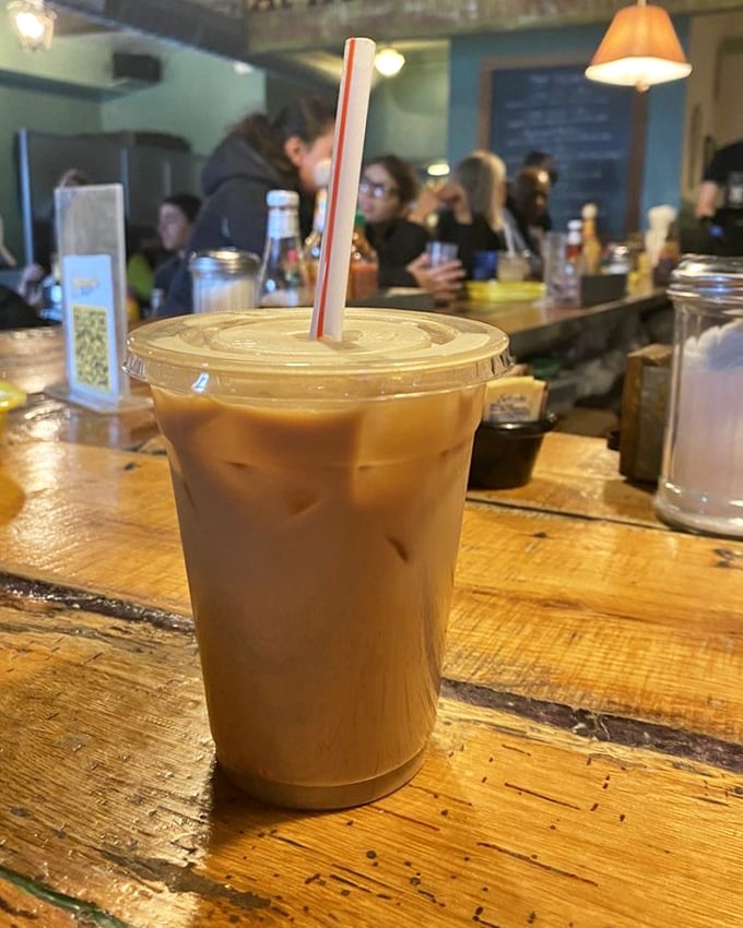 Their iced vanilla latte isn't just coffee—it's liquid motivation sitting on a wooden counter that's witnessed countless morning revelations.