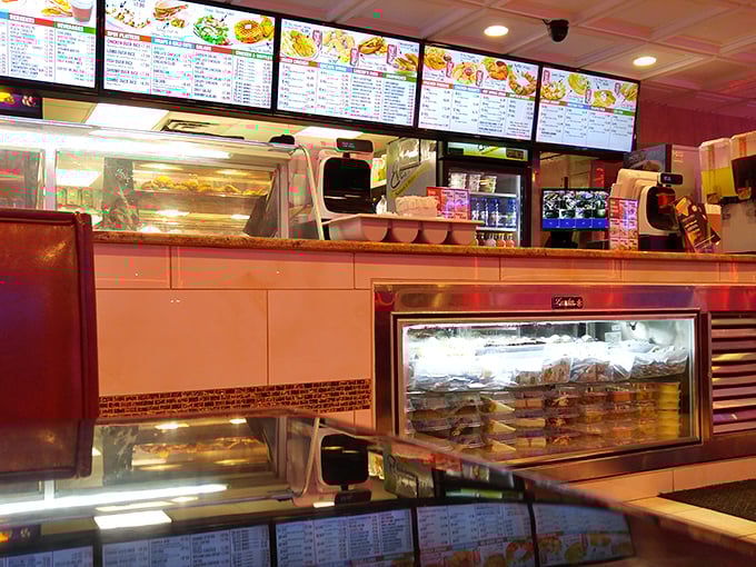 The counter view—where culinary dreams are born and the aroma of fresh fried chicken makes waiting for your order a delicious form of torture.