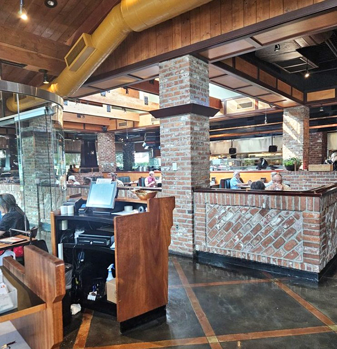 Exposed beams, brick columns, and the gentle hum of satisfied diners—a restaurant interior that feels like a warm Smoky Mountain hug.
